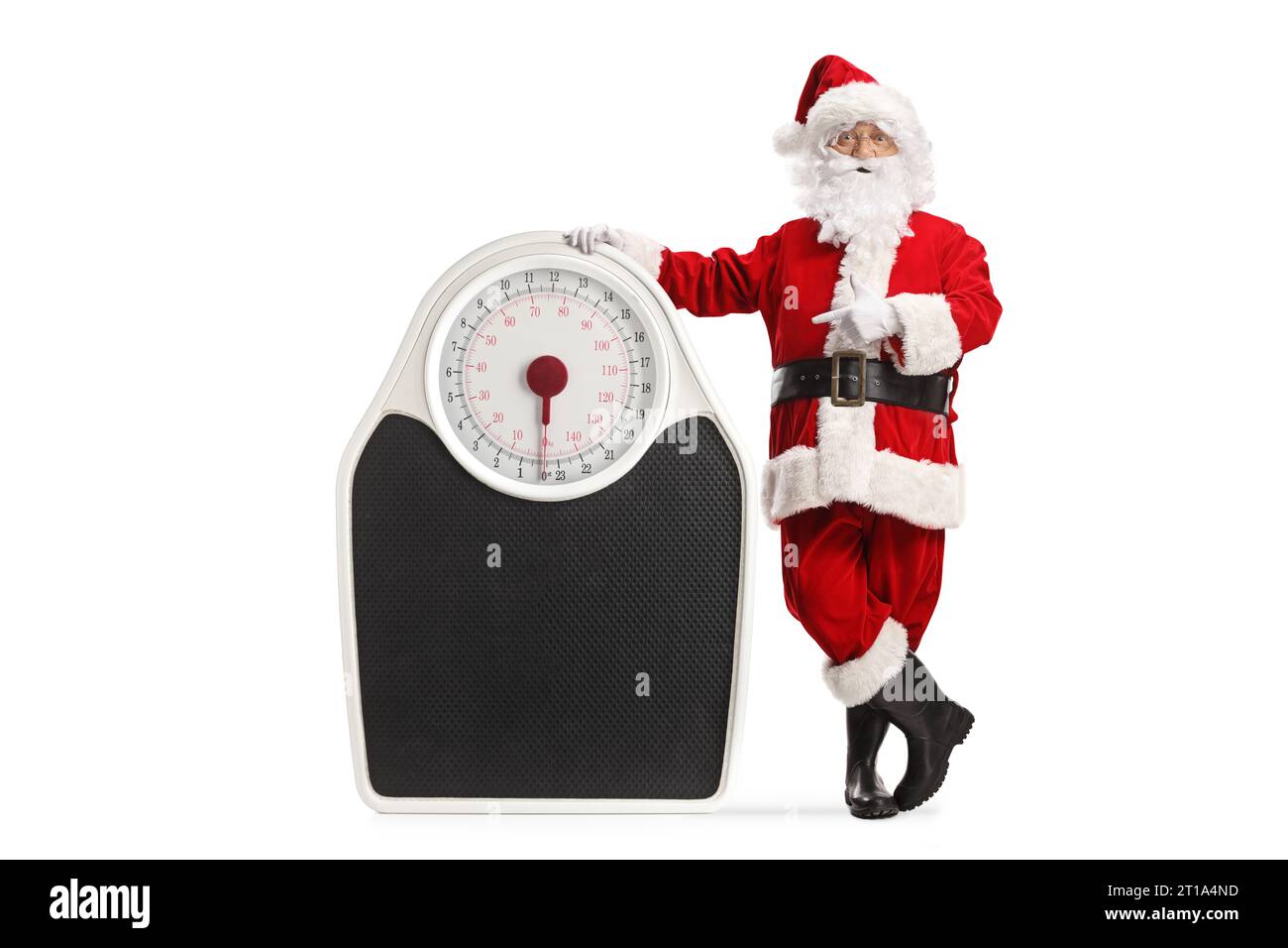 Santa Claus pointing at a big weight scale isolated on white background ...