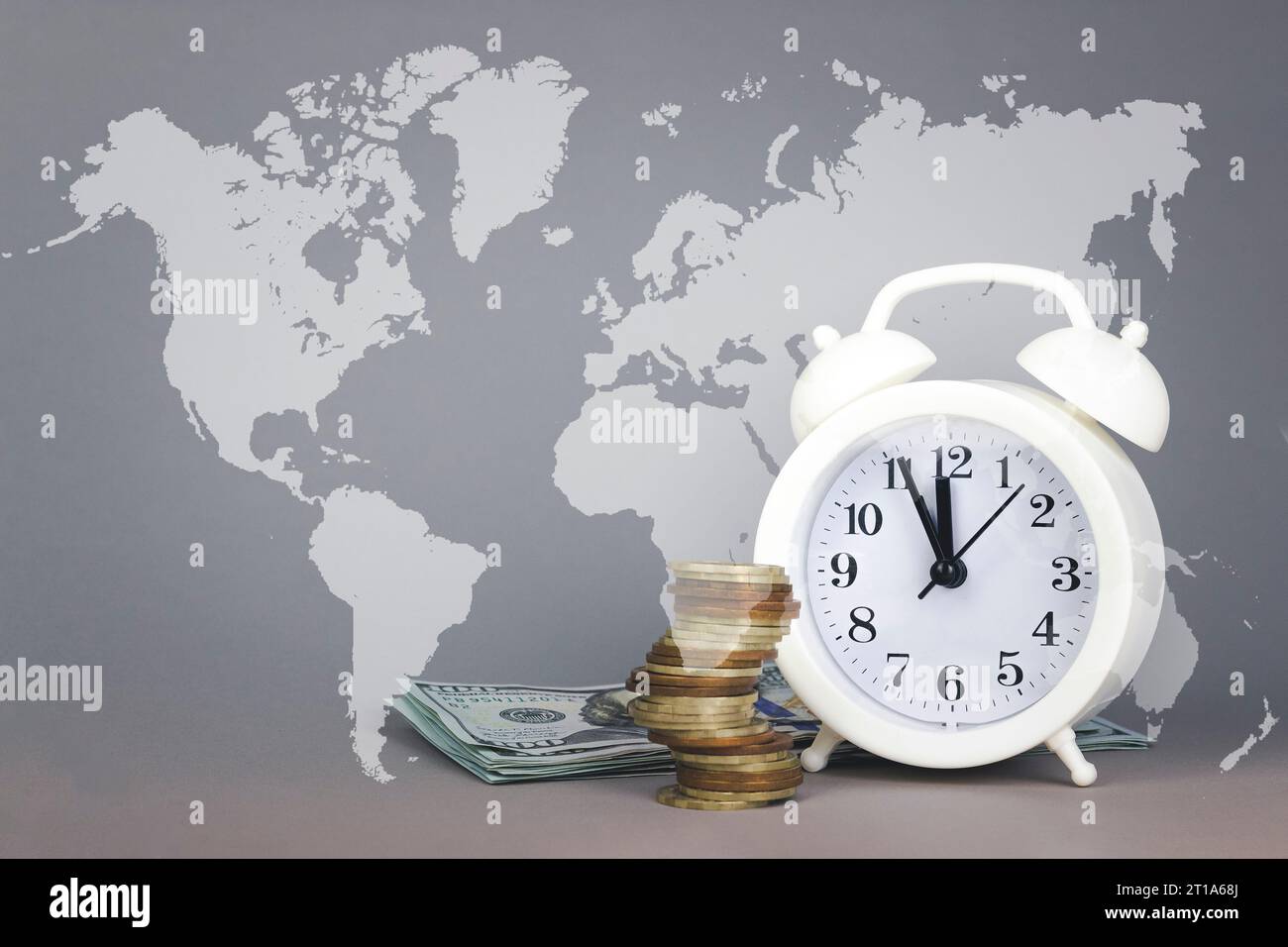 White alarmclock with Coins stack and stack of one hundred dollar bills ...