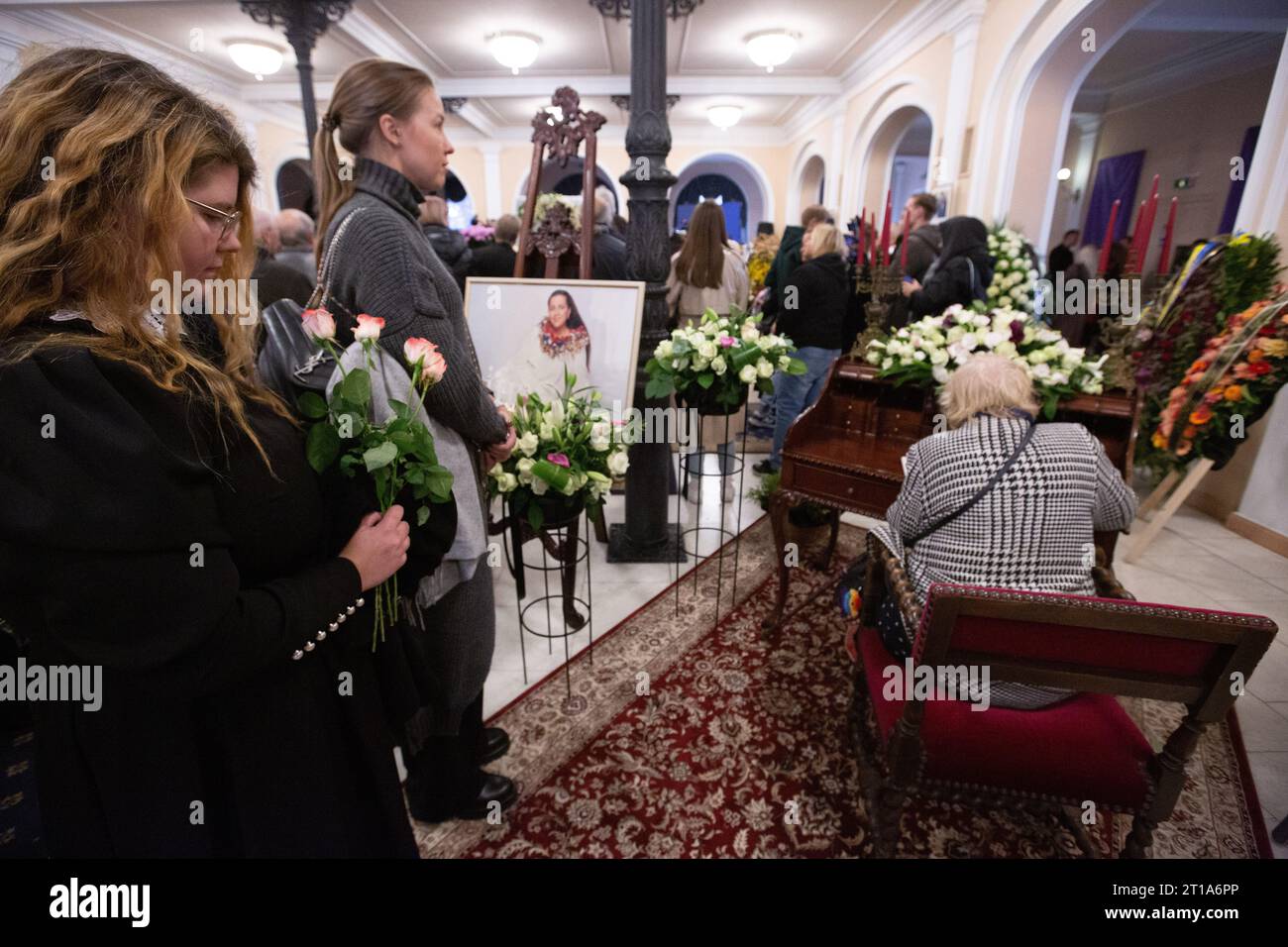 People stand in line to sign the book of condolence during the funeral ...