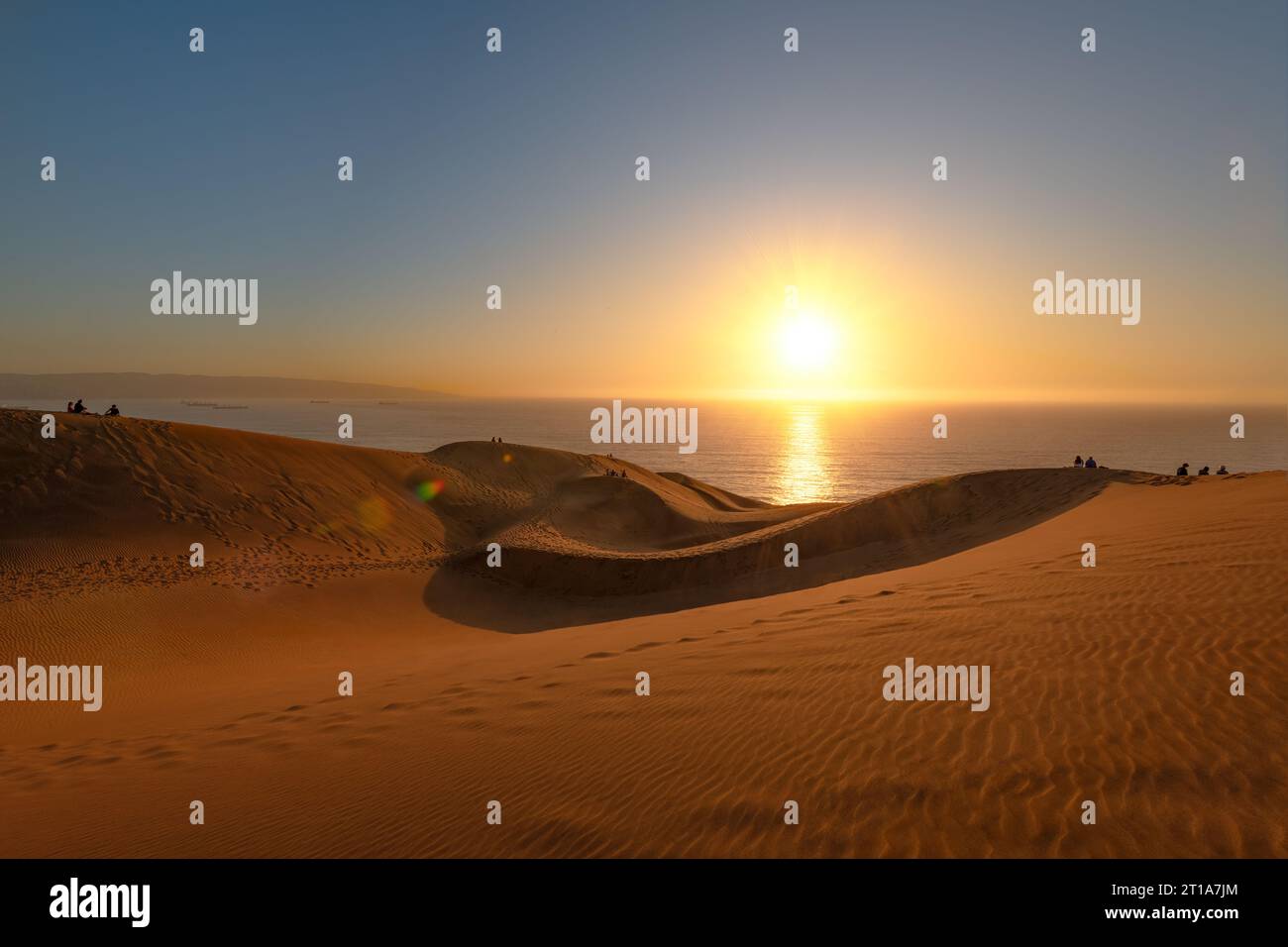 People watching the sunset from the dune field of Concon, Chile Stock ...