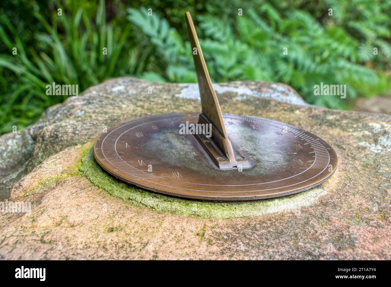 vintage sundial garden metal bronze , casting a shadows on the dial ...