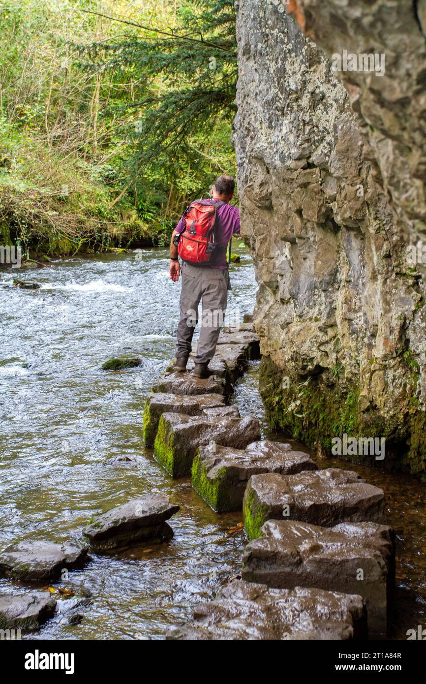 Man walking on the stepping stones in the river Wye while walking ...