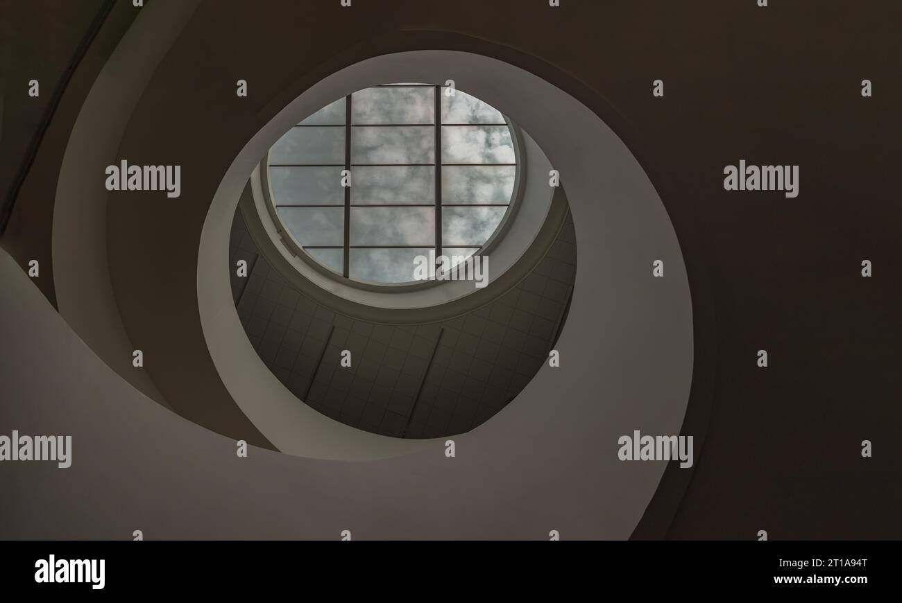 Looking up to the sky through modern channel round circular ceiling ...