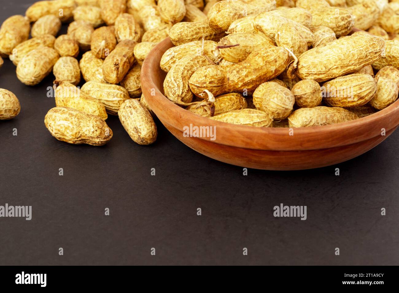 Roasted peanuts, peanuts in shell Isolated on black background Stock ...