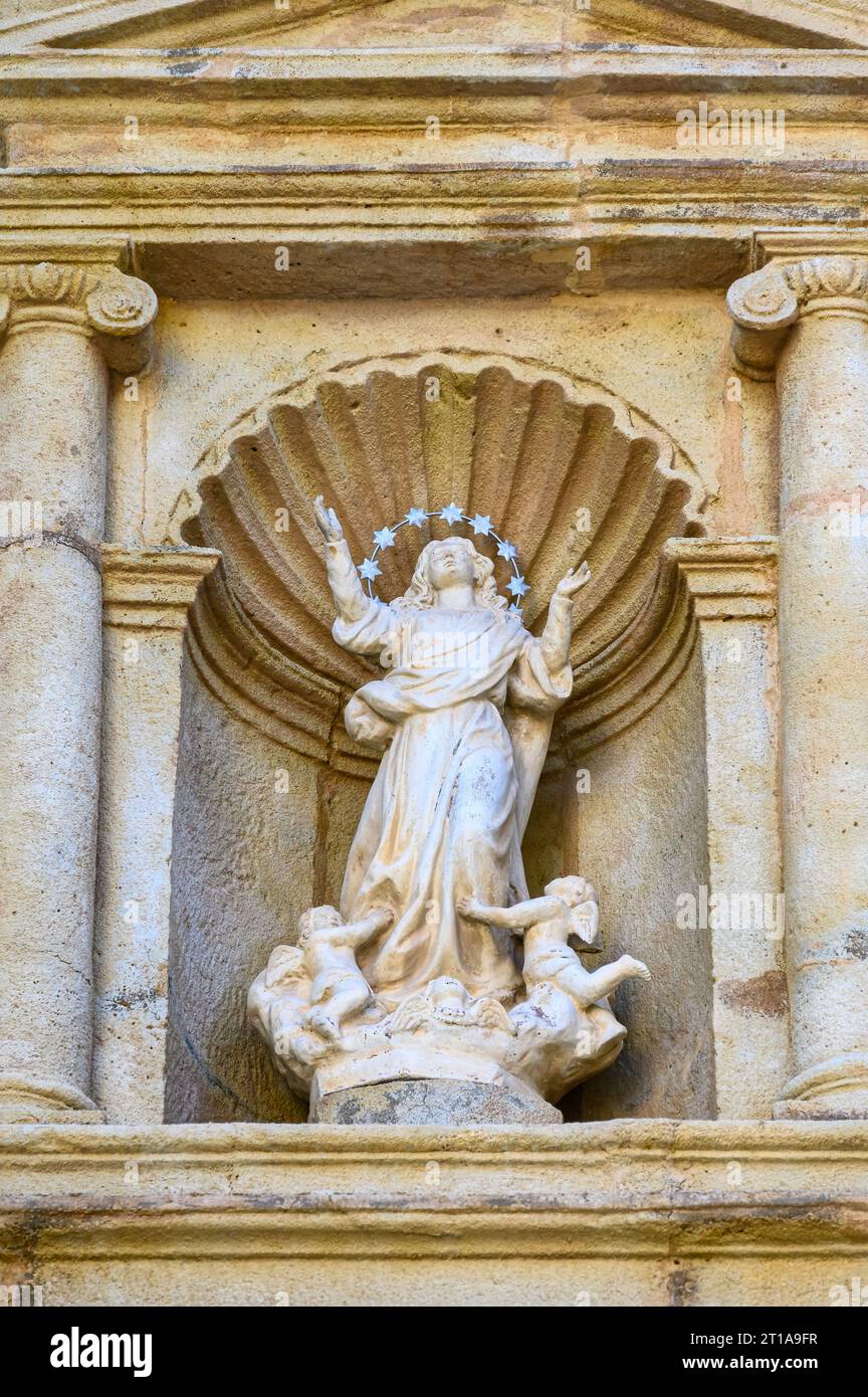 Medieval sculpture of a religious saint in the facade of the local ...