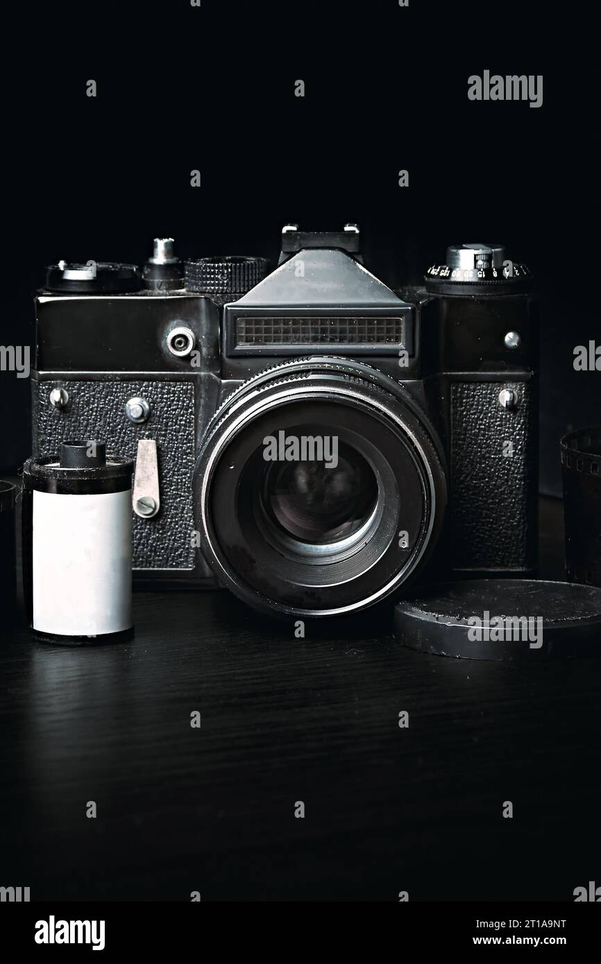 Old film rangefinder SLR, film reel, lens cap, black and white tinting ...