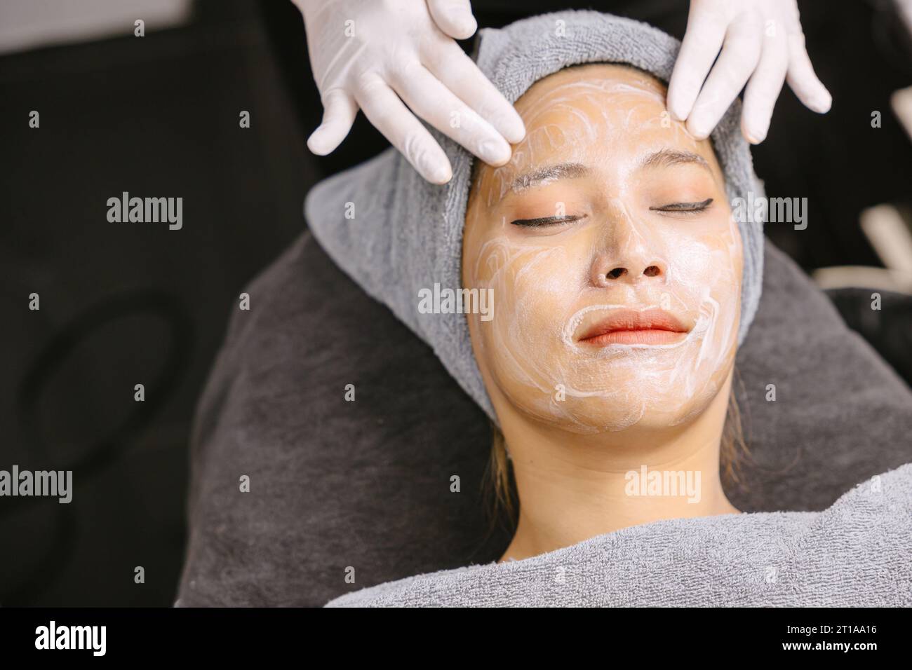 Woman facial massage face skin treatment with natural essence herbal ...