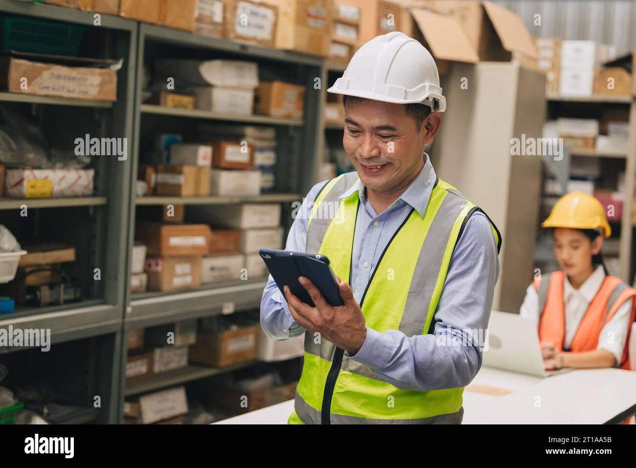 Engineer warehouse manager happy using inventory management technology ... Engineer warehouse manager happy using inventory management technology ...