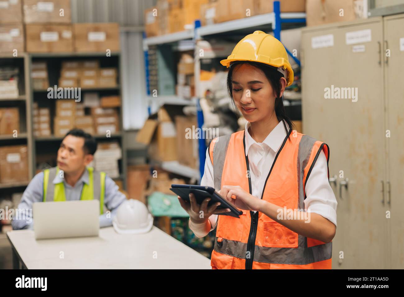 Engineer woman work in hardware products warehouse store using tablet ...