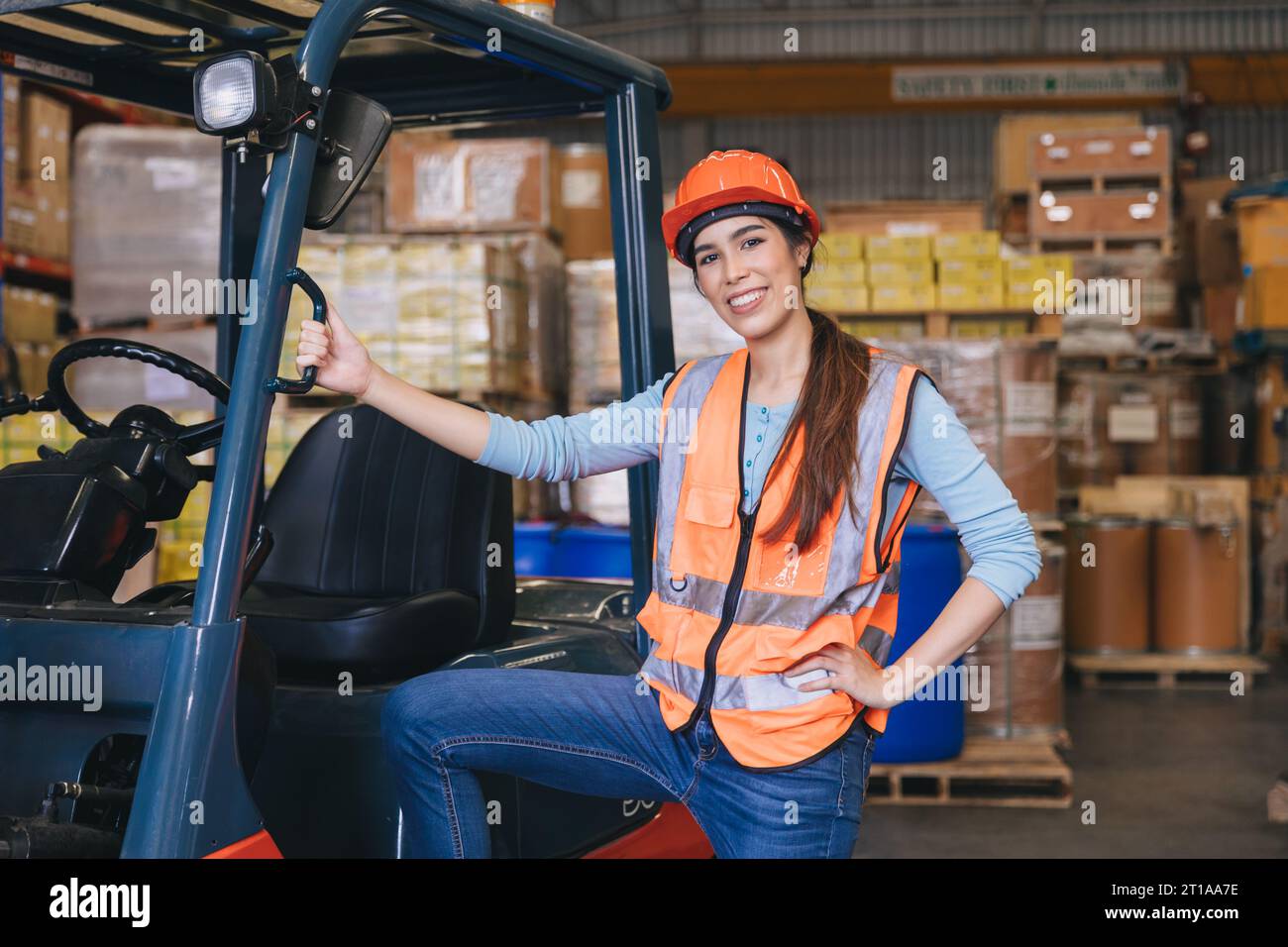 happy woman forklift staff worker work in warehouse logistics loading cargo products storage ...