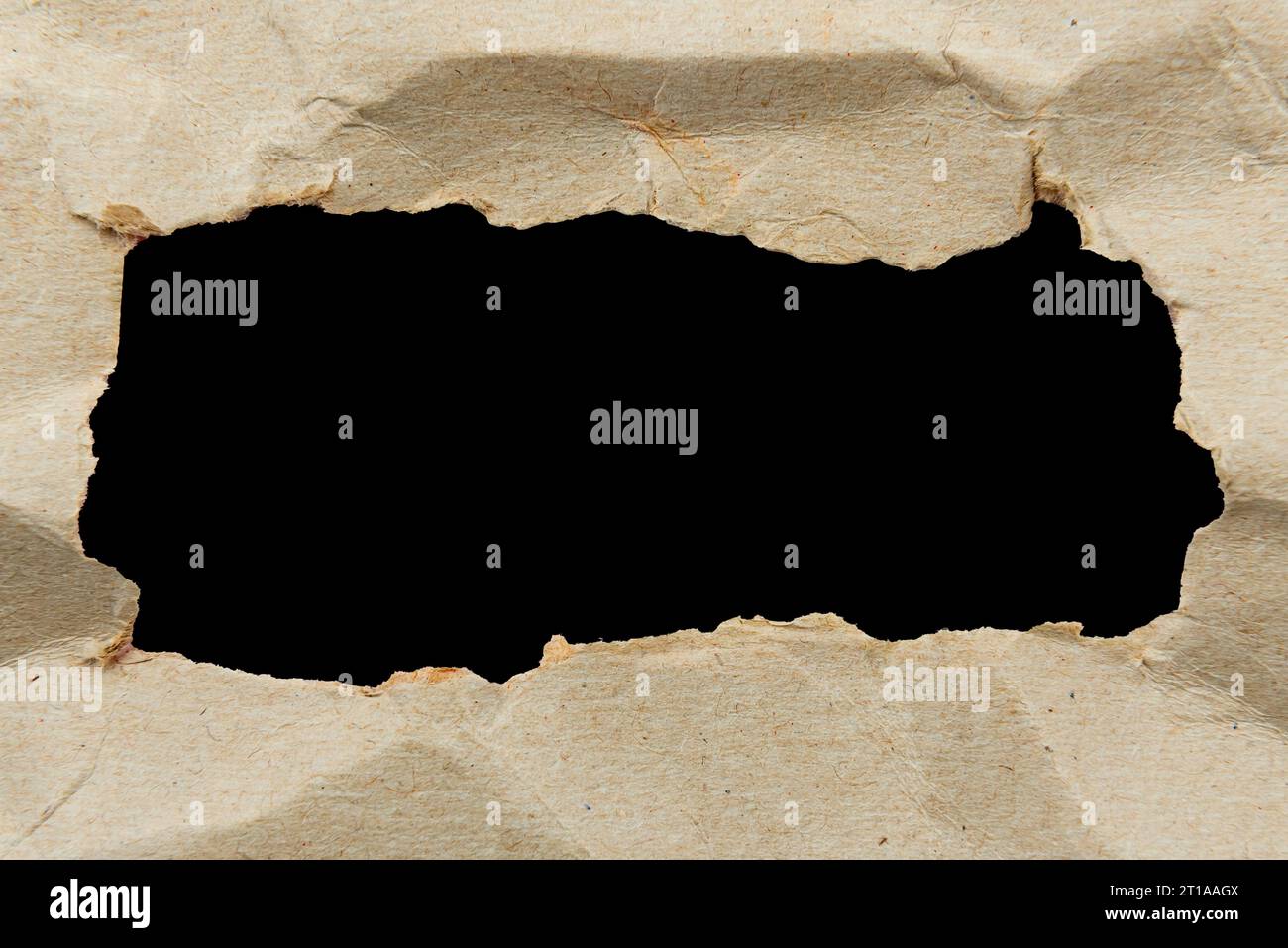 A hole in cardboard or paper. A torn piece of paper Stock Photo - Alamy