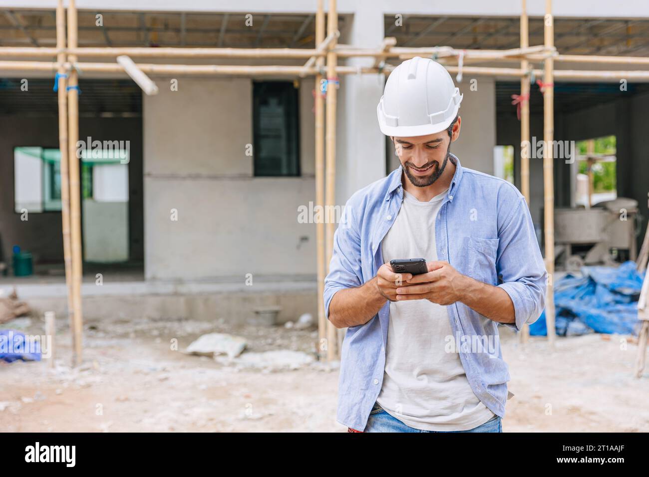 happy foreman builder using smart phone calling business contact in ...