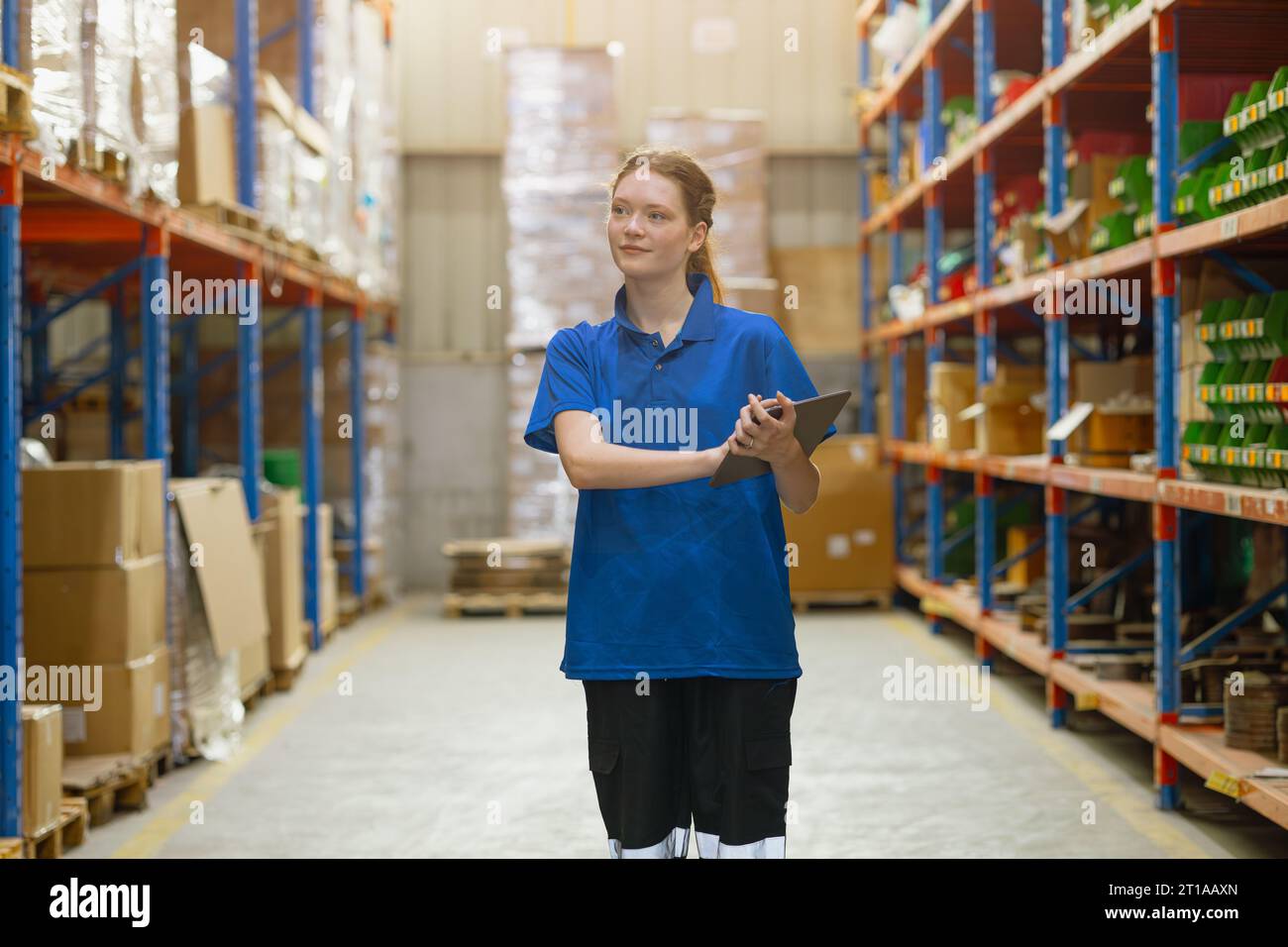 Young caucasian woman worker use tablet technology checking stock in warehouse cargo goods ...