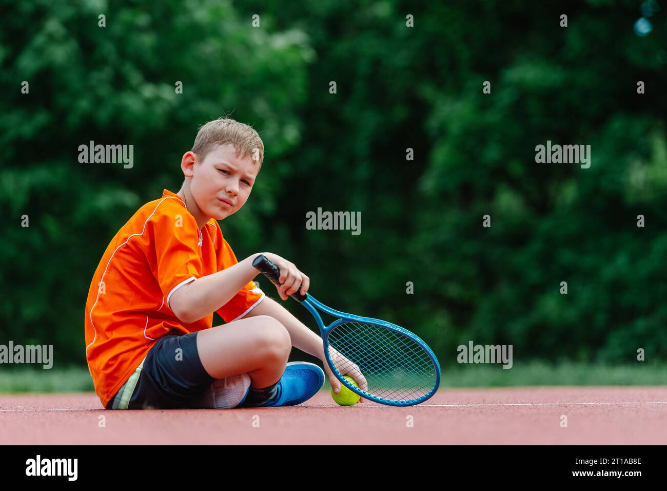 Child with tennis racket on tennis court. Training for young kid ...