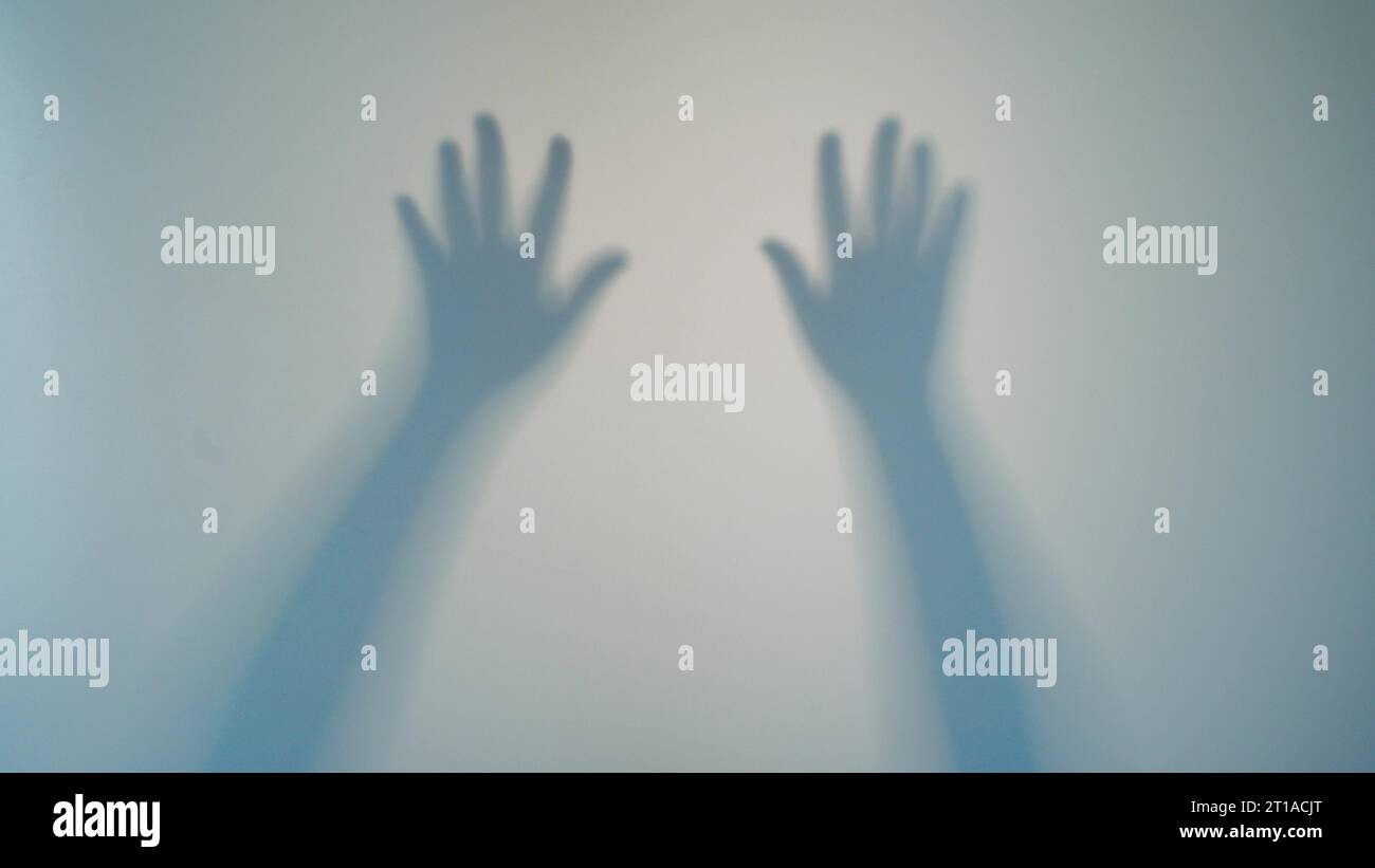 Shadow Blur of a horror man behind frosted glass. Blurred hand, body ...