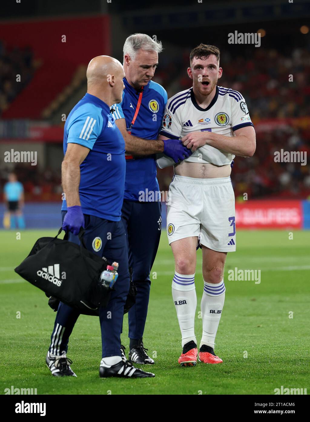 Scotland's Andrew Robertson is helped from the pitch after picking up ...