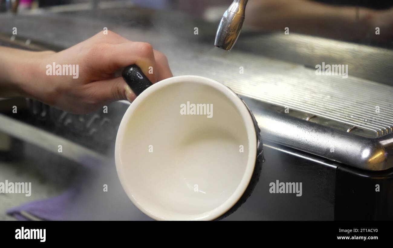 Blowing the steam tube of the coffee maker. Disinfection of dishes with ...