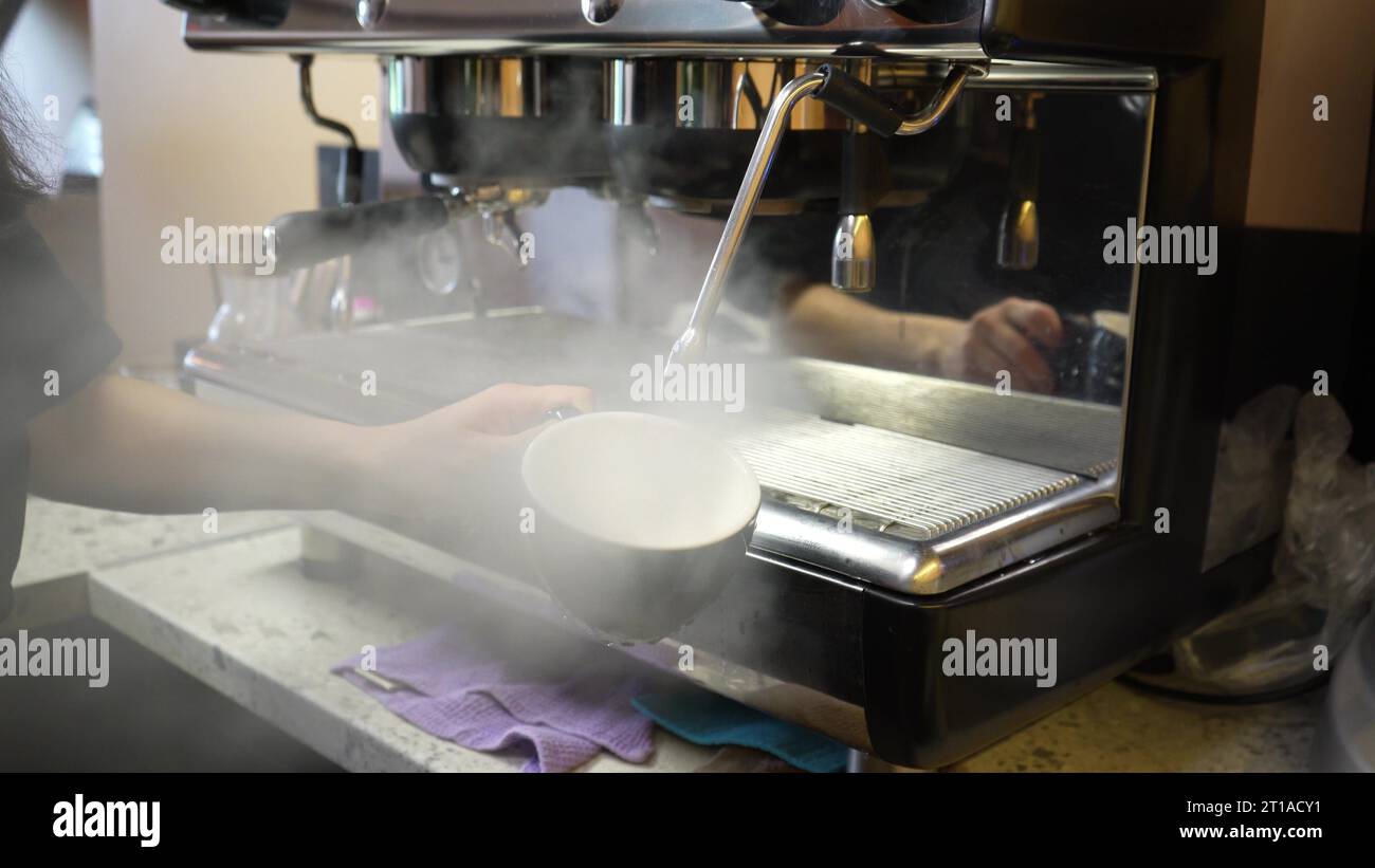 Blowing the steam tube of the coffee maker. Disinfection of dishes with ...
