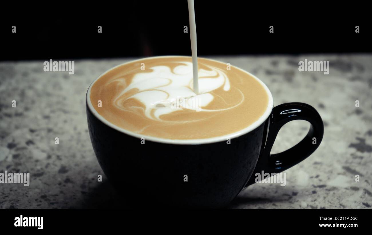 The barista steams the milk. The process of creating milk foam. Latte ...