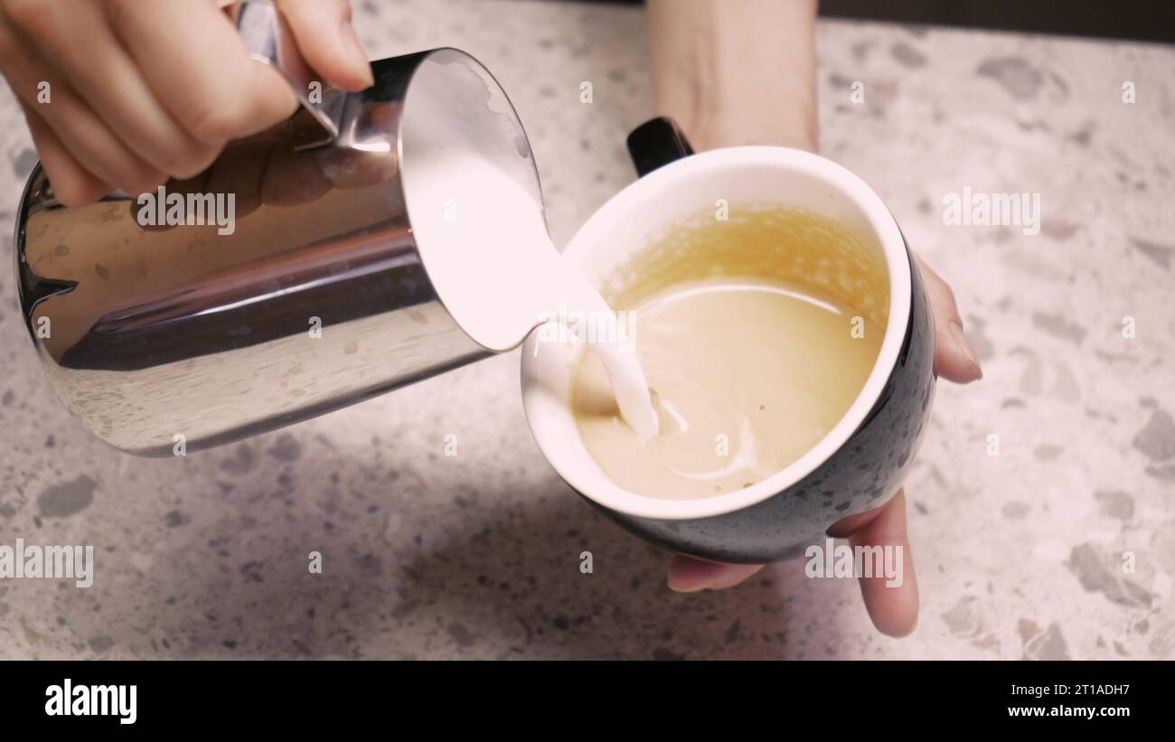 The barista steams the milk. The process of creating milk foam. Latte ...