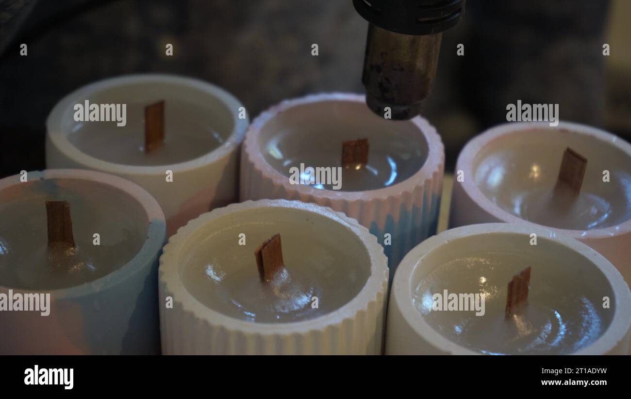 The process of processing finished candles with a hair dryer to level ...