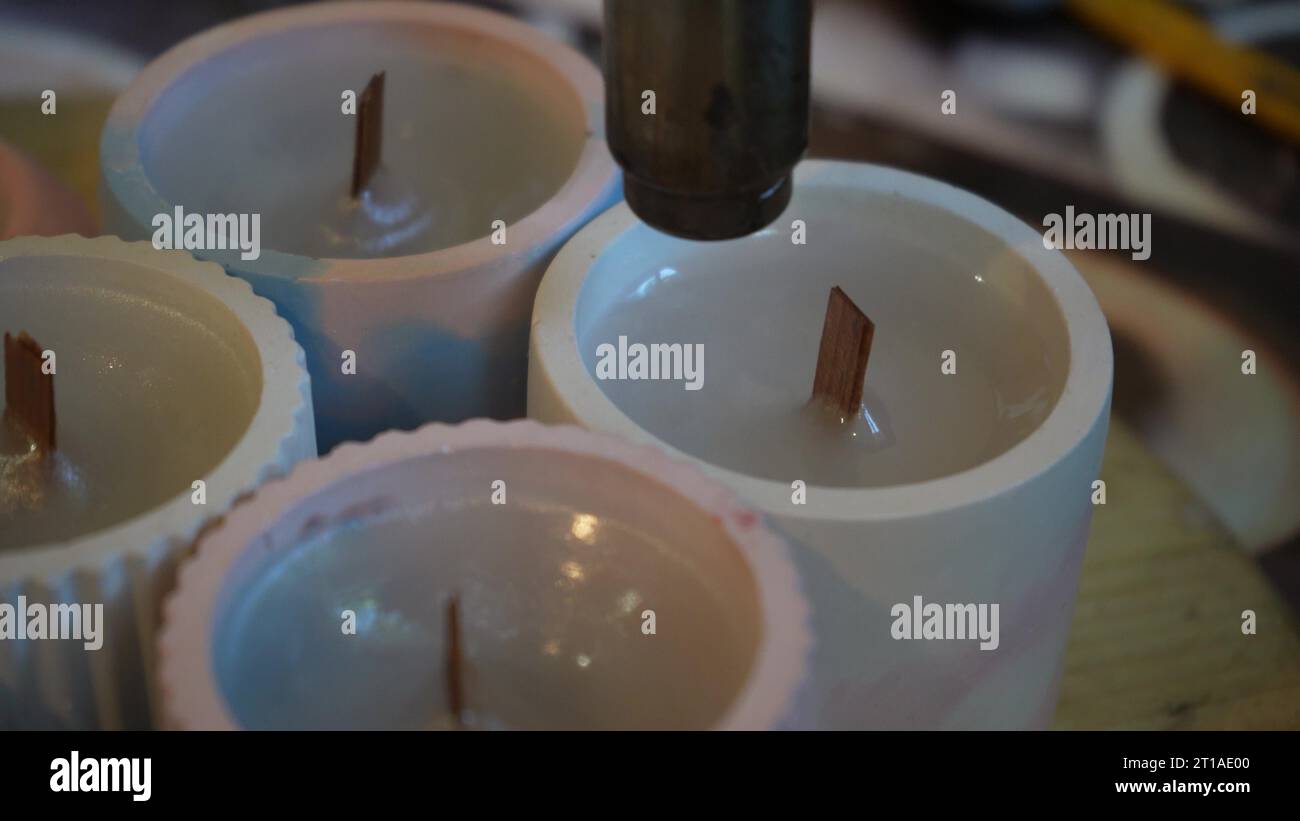 The process of processing finished candles with a hair dryer to level ...