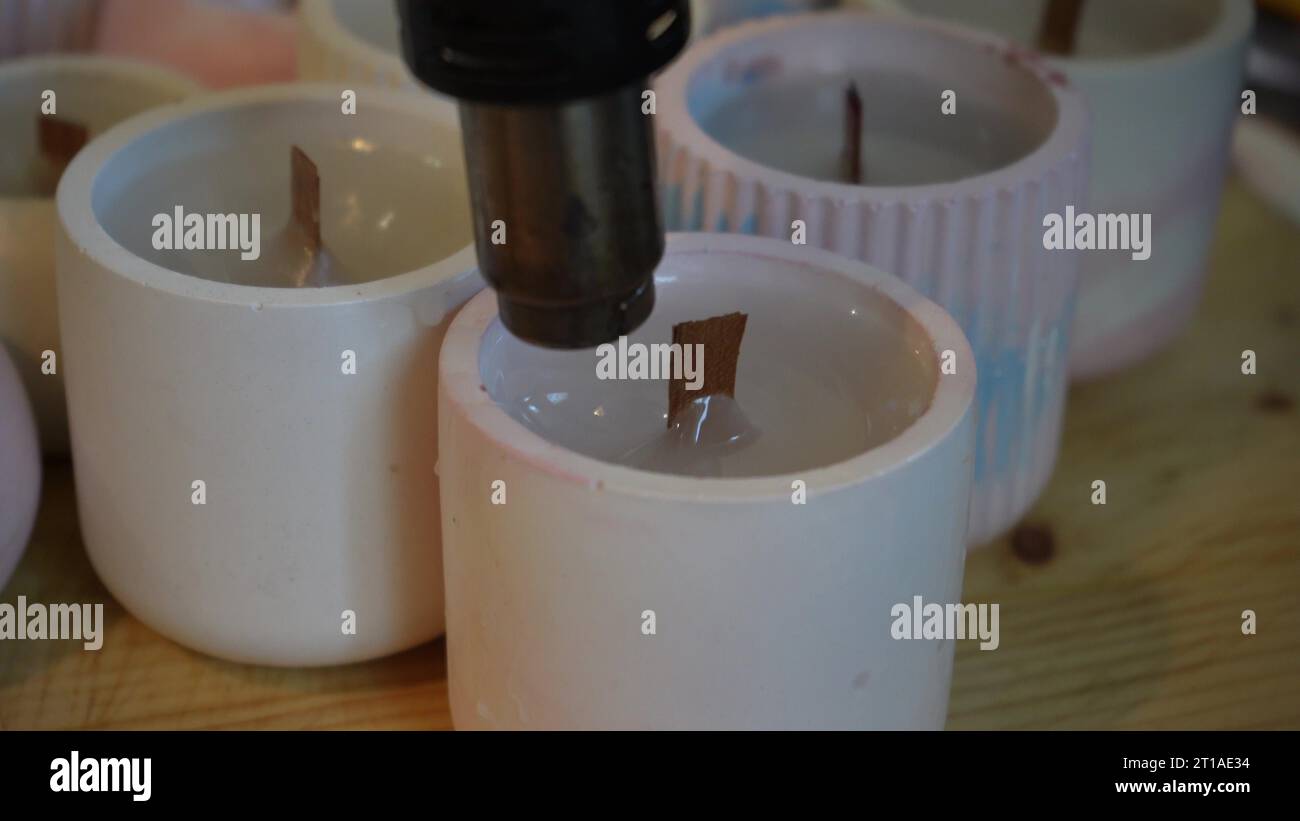 The process of processing finished candles with a hair dryer to level ...