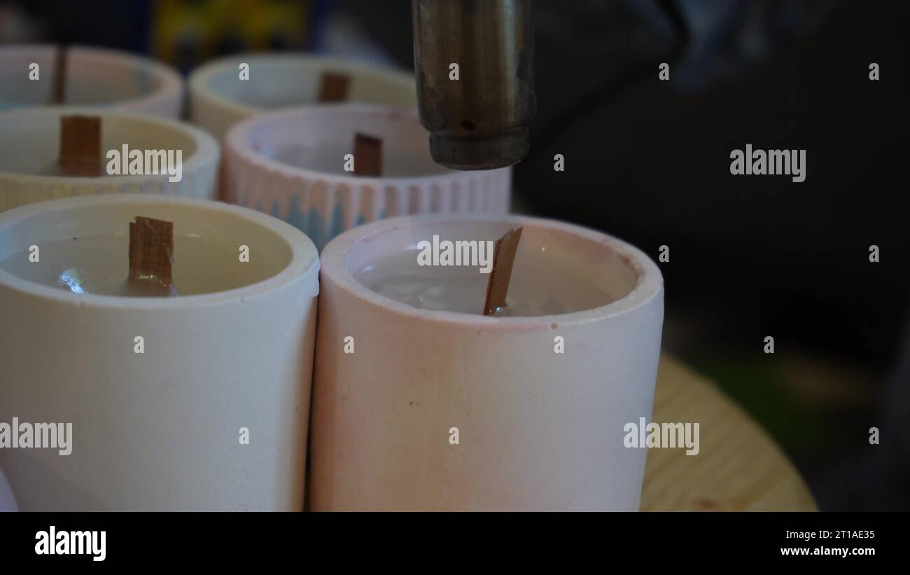 The process of processing finished candles with a hair dryer to level ...