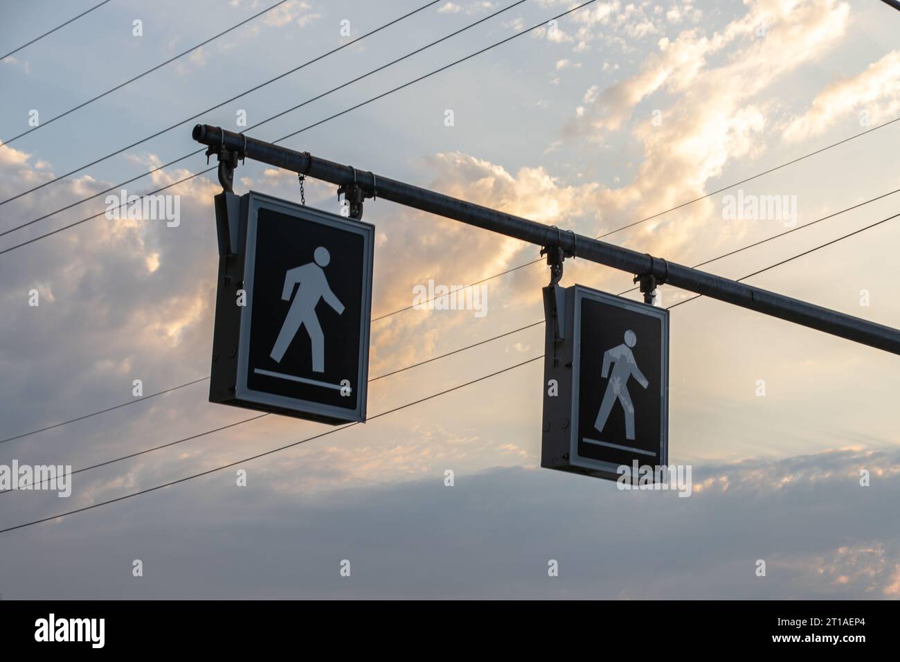Two pedestrian road sign at sunset Stock Photo - Alamy
