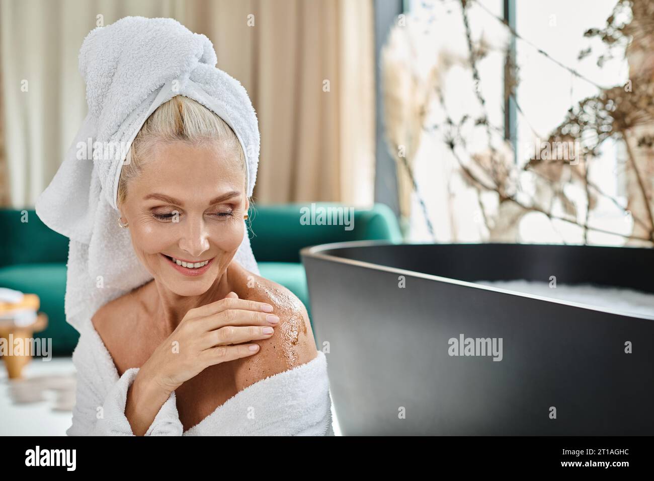 Happy Middle Aged Woman In White Bathrobe And With Towel On Head
