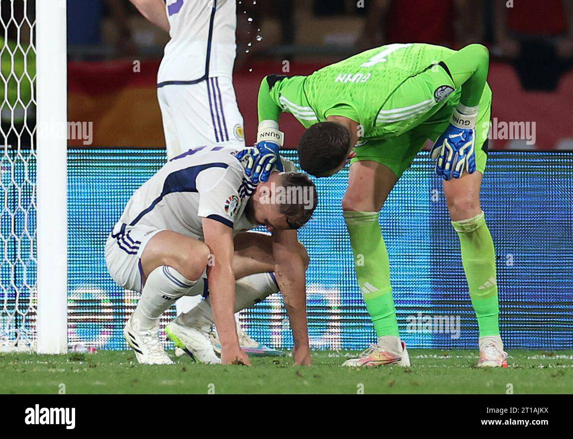 Scotland's Ryan Porteous is consoled by Angus Gunn after scoring an own ...