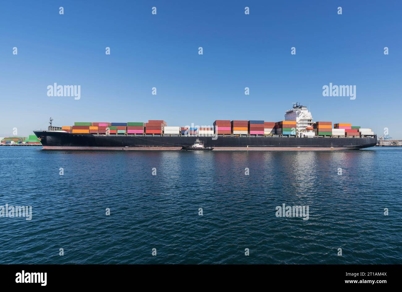 View of freight container cargo ship with tug boat in Los Angeles ...