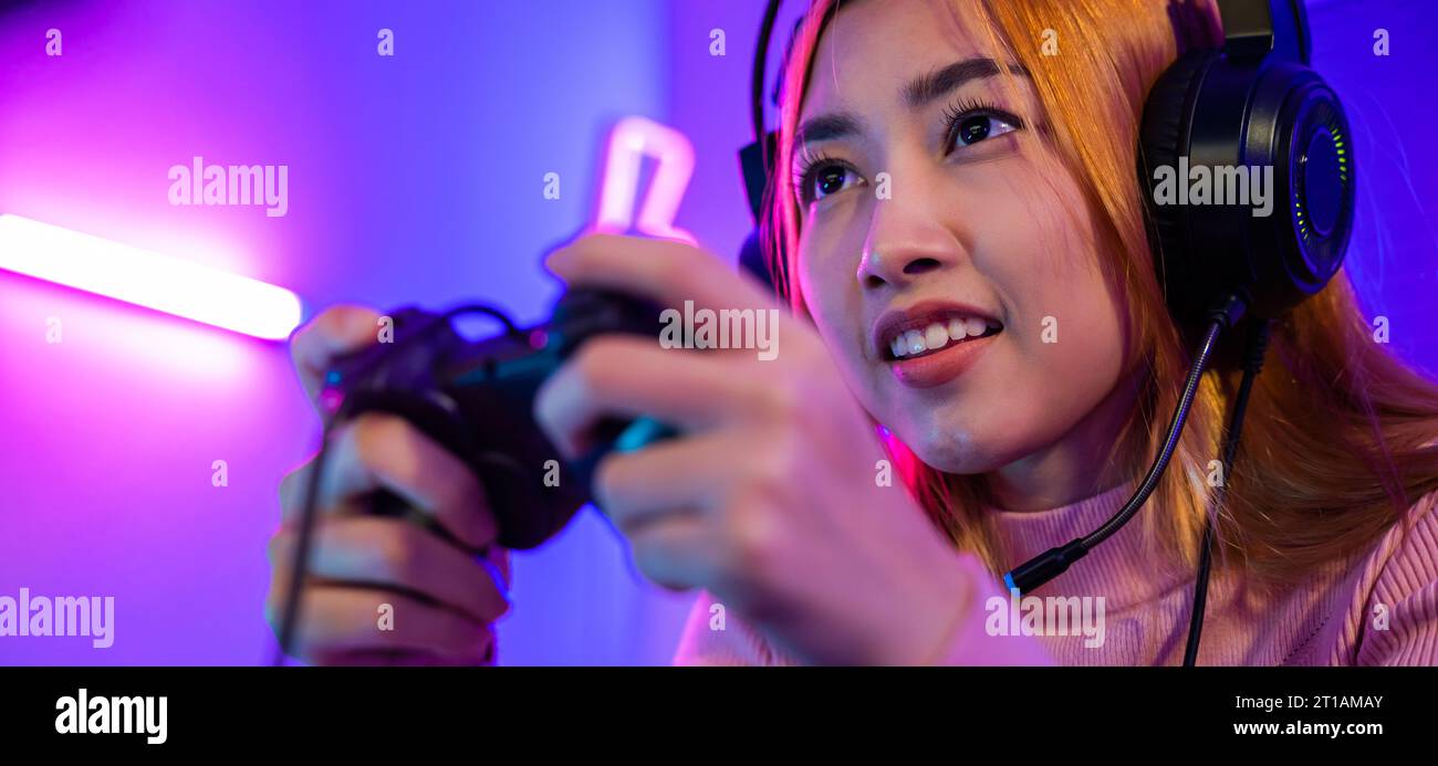 Gamer using joystick controller plays online video game with computer ...