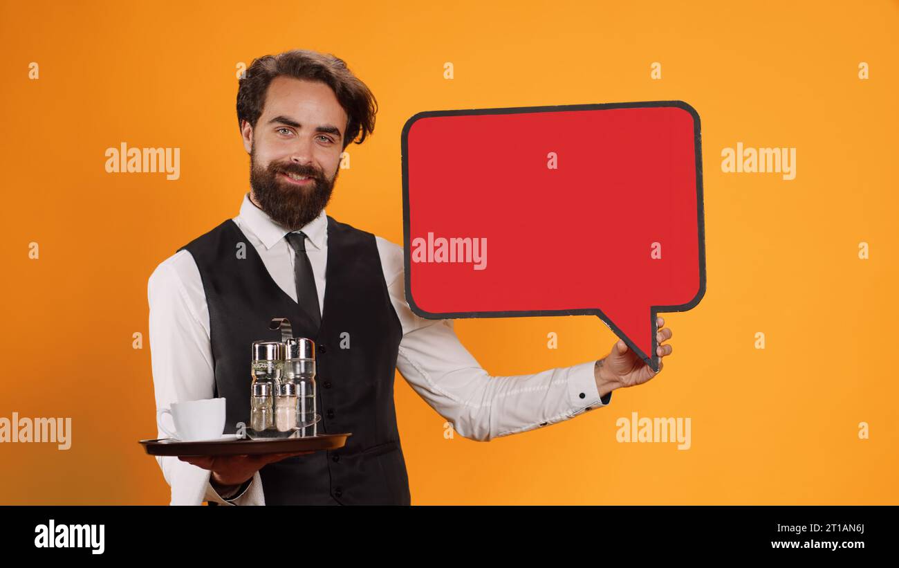 Luxury butler presents blank speech bubble in studio, working at five ...