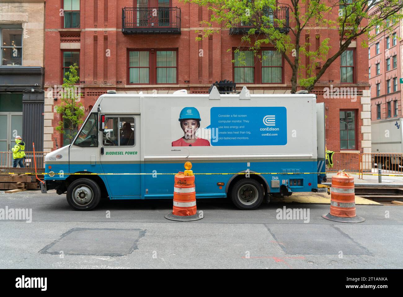 Workmen and a truck from the electrical company that services much of ...