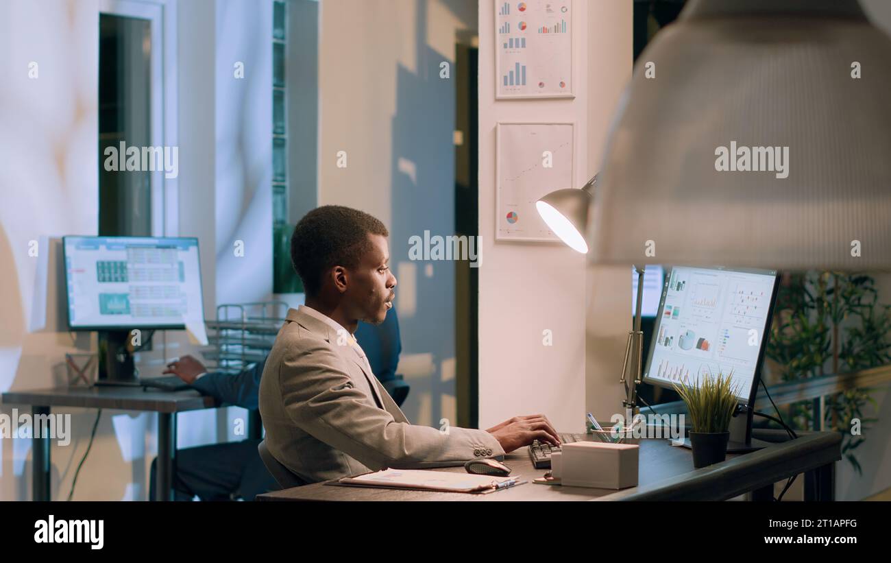 African american manager asking employee to show him company project ...