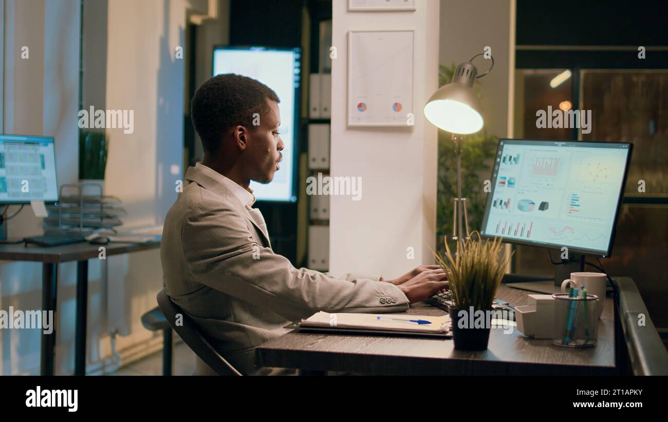 Feeling exhausted working late in evening on computer in office hi-res ...