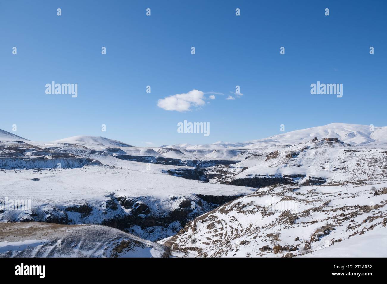 Snowy hills landscape background with clear blue sky. Selective focus ...