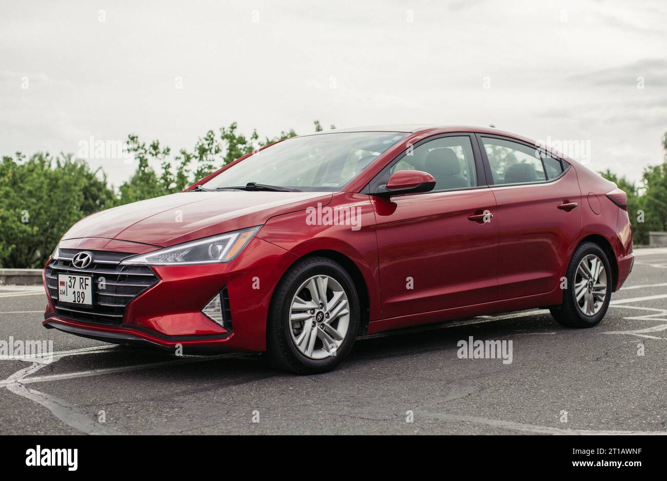 A brand new red Hyundai car gleaming in the sunlight parked in a lot ...