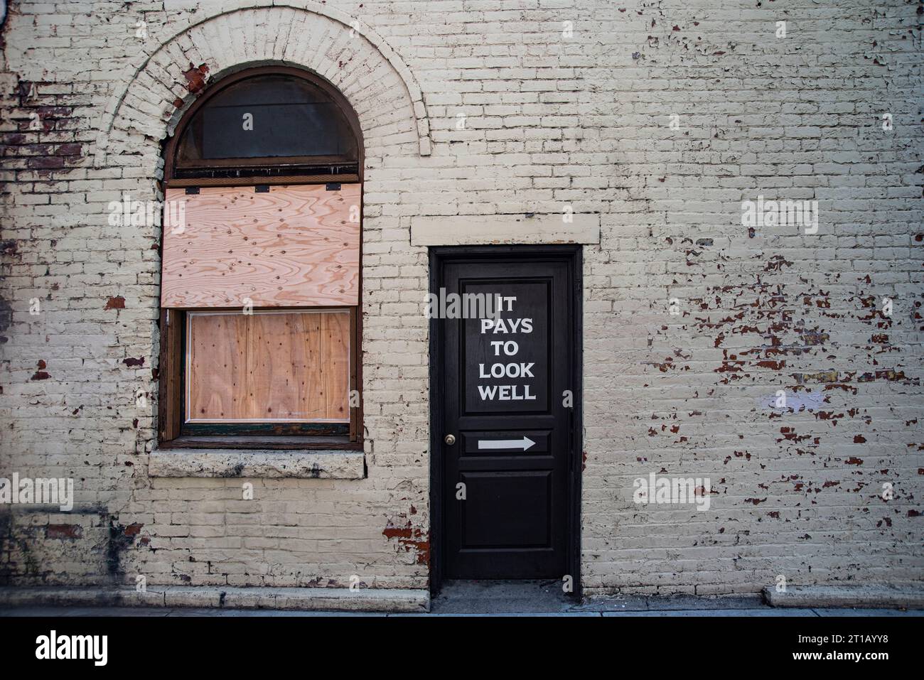 Boarded up window and inspirational sign on wall of old Sav-On Cafe ...