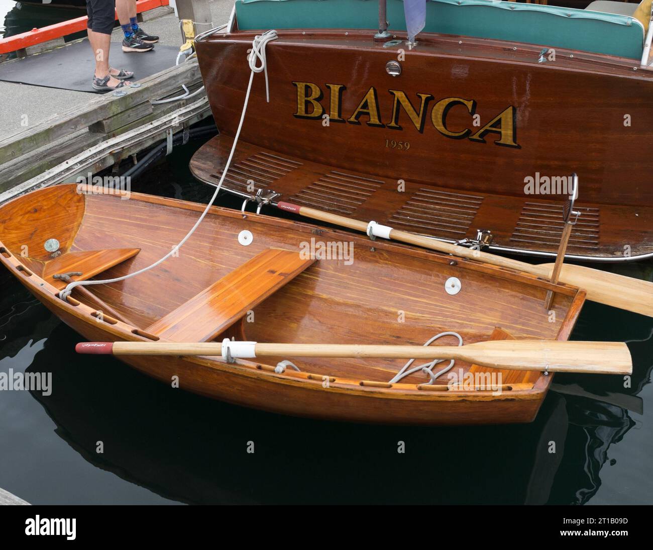 A classic wooden dinghy tied to its mother ship at the annual Victoria ...