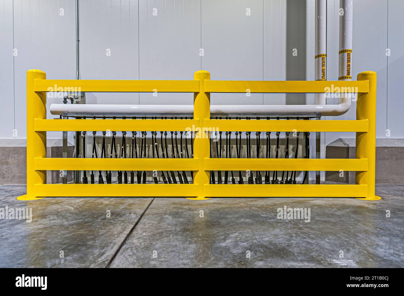 Yellow guard rail and piping for floor warming on loading dock in a ...