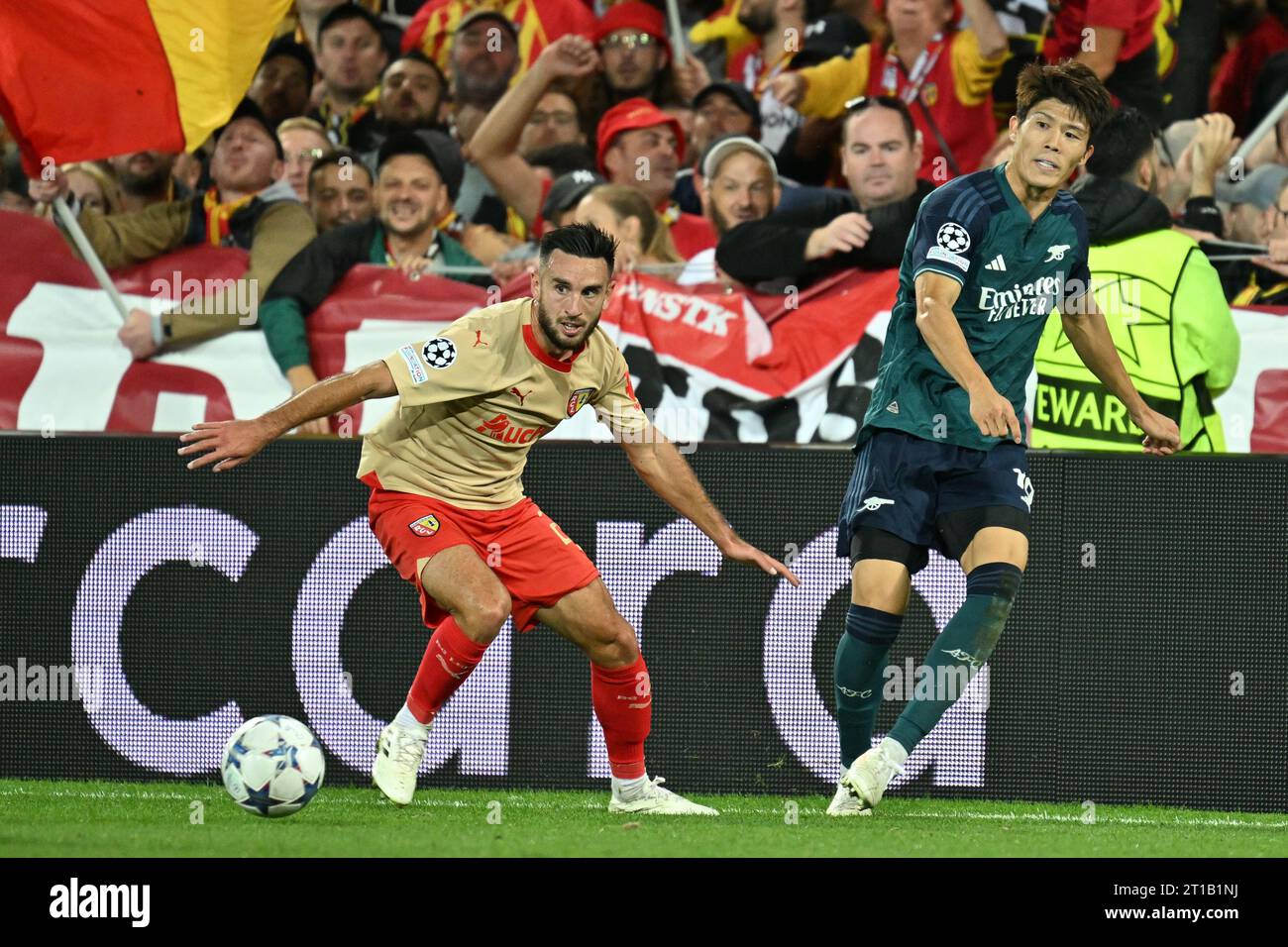 Adrien Thomasson (28) of RC Lens and Takehiro Tomiyasu (18) of Arsenal ...