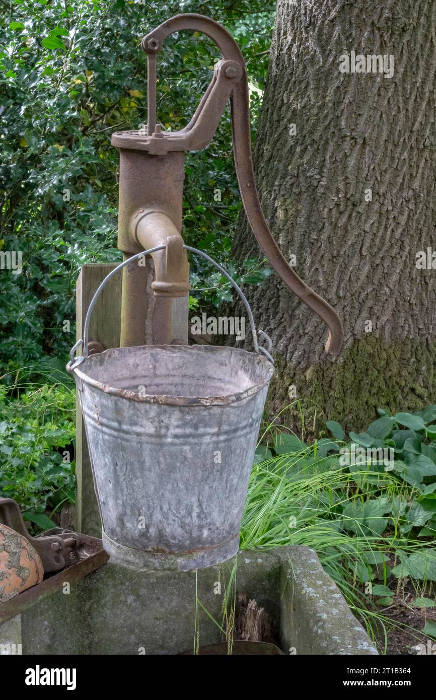 Old Schwengelpumpe and old water bucket made of zinc, North Rhine ...