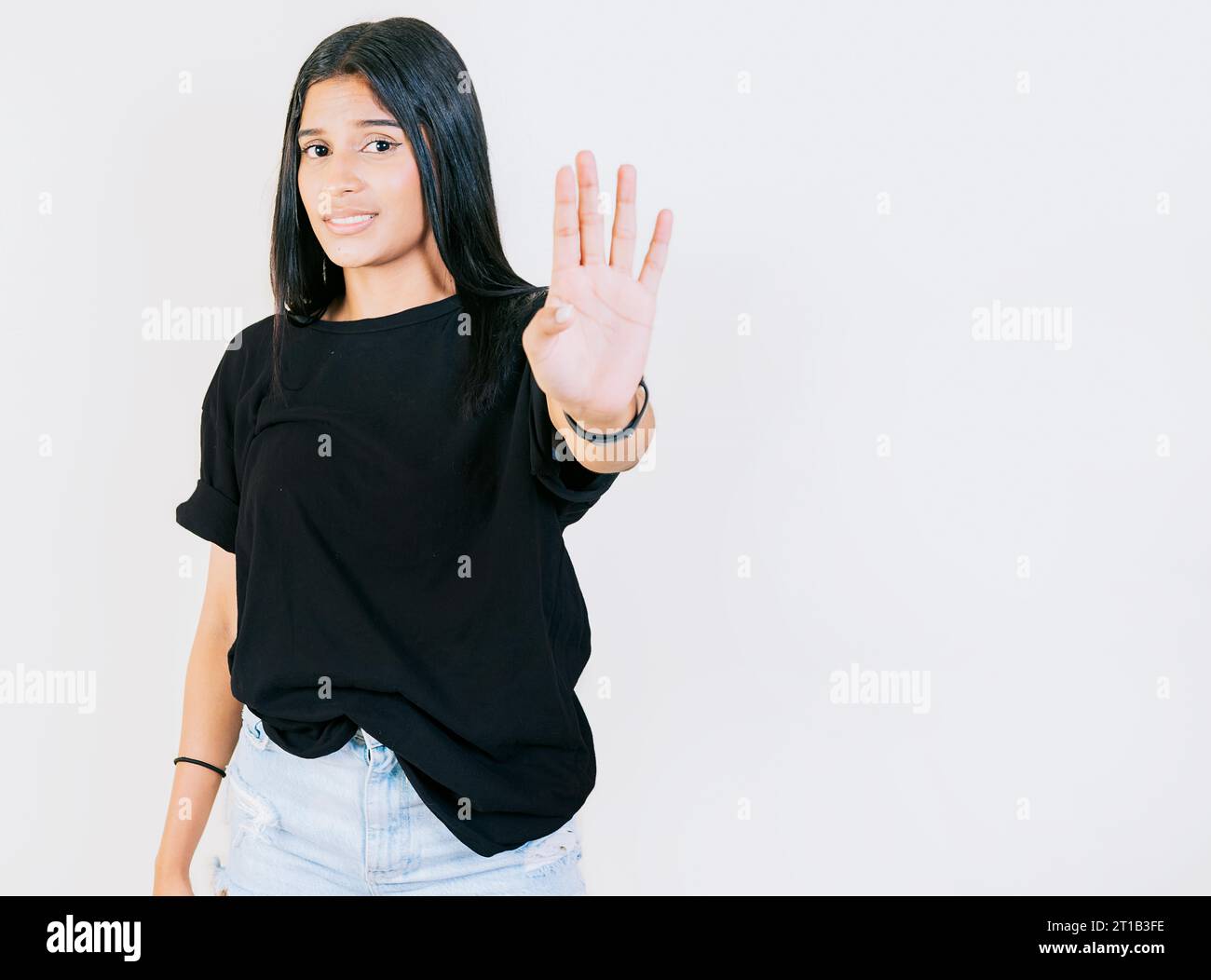 Teen girl gesturing stop with palm hand isolated. Young woman rejecting ...