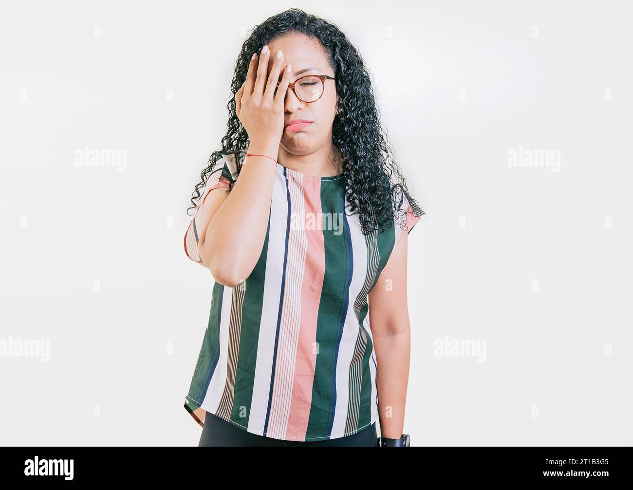 Worried young woman holding his forehead. Stressed young woman holding ...