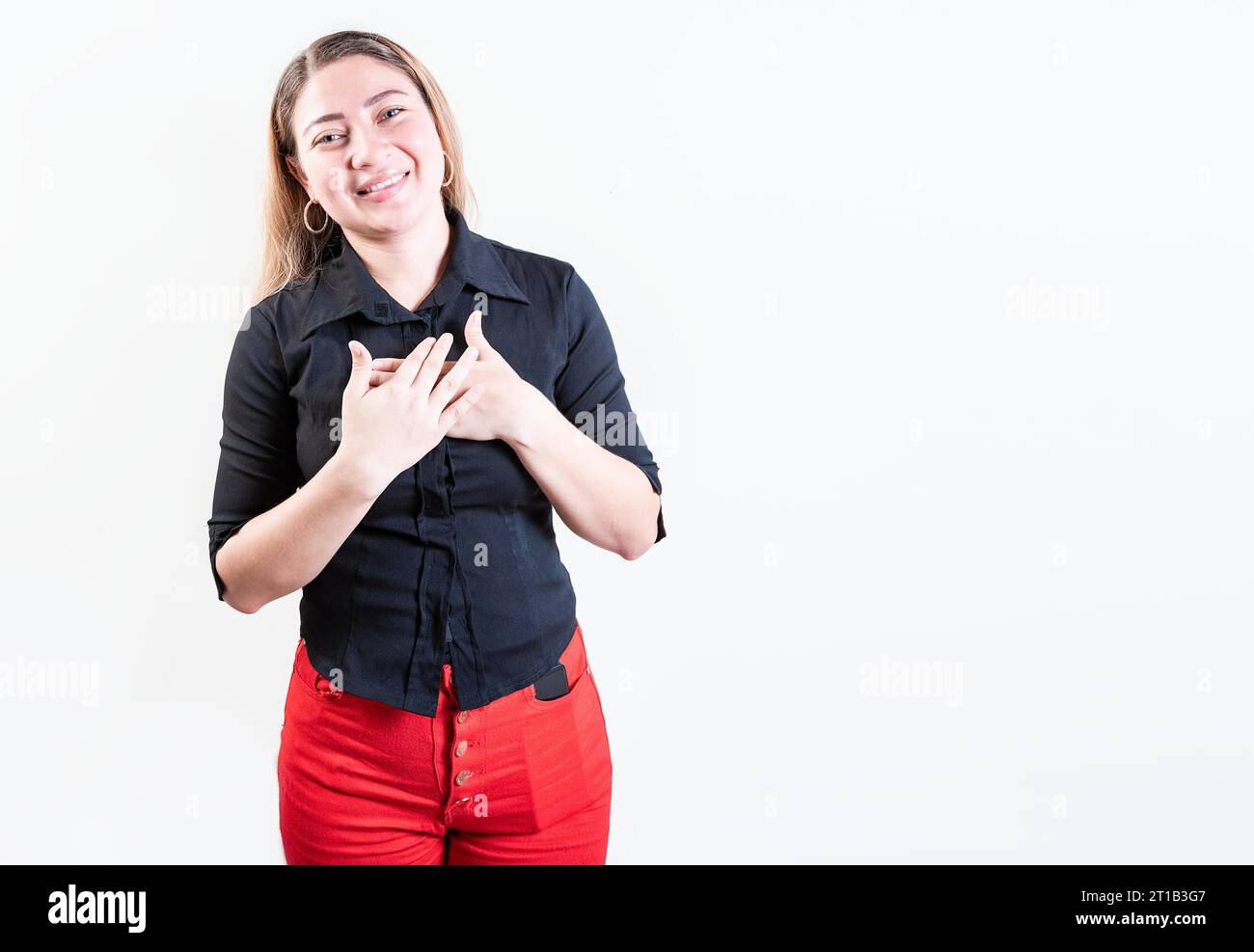 Thankful young woman with hands on chest. Grateful teenage girl smiling ...