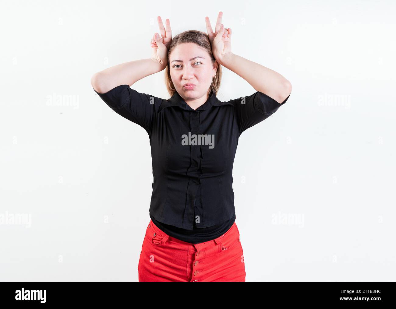 People making horns gesture with their fingers, gesture of betrayal ...