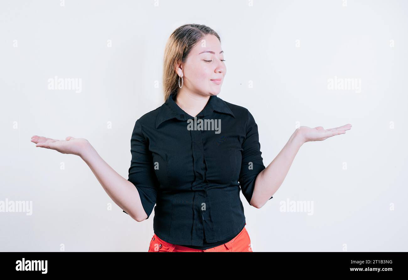 Smiling woman comparing with palms with hands isolated. Girl balancing ...