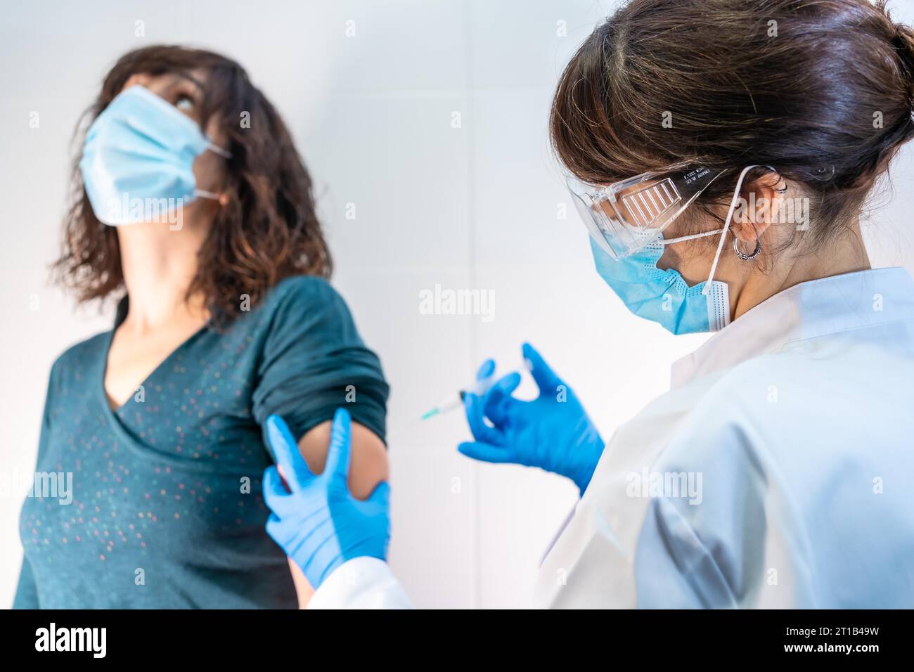 Coronavirus vaccine applied to a young woman by a doctor. Antibodies ...
